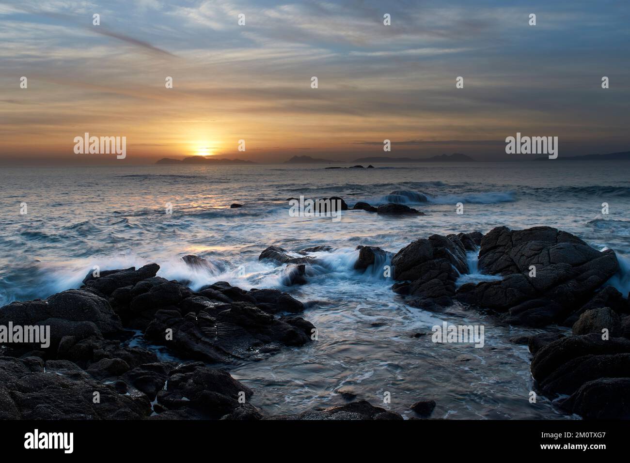 Sunset over rocky coastline hi-res stock photography and images - Alamy