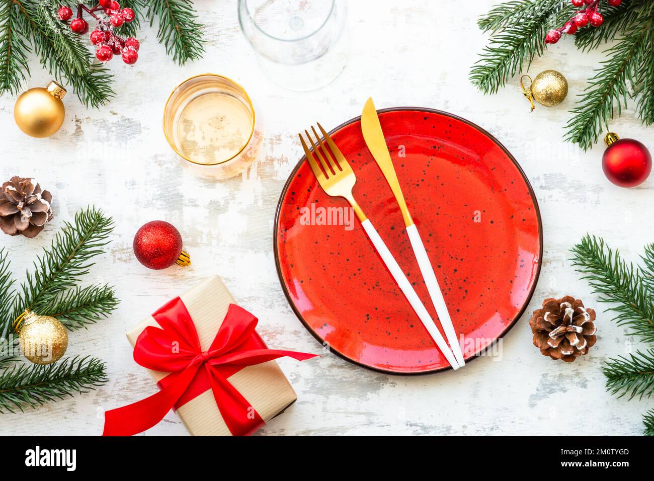 Christmas table setting with plate, cutlery and christmas decorations ...