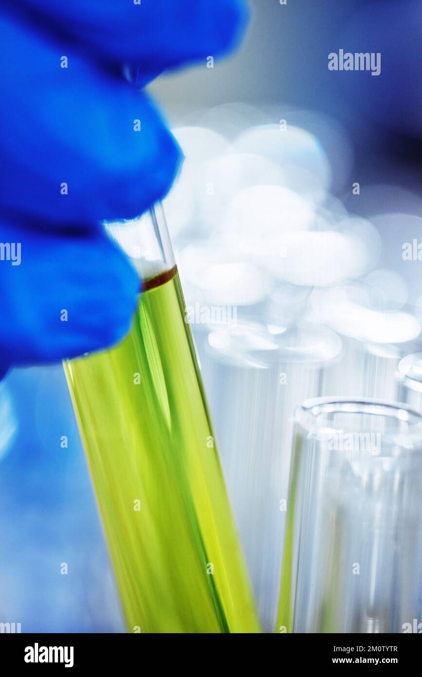 Steady hands are required. an unknown scientist inserting a test tube ...