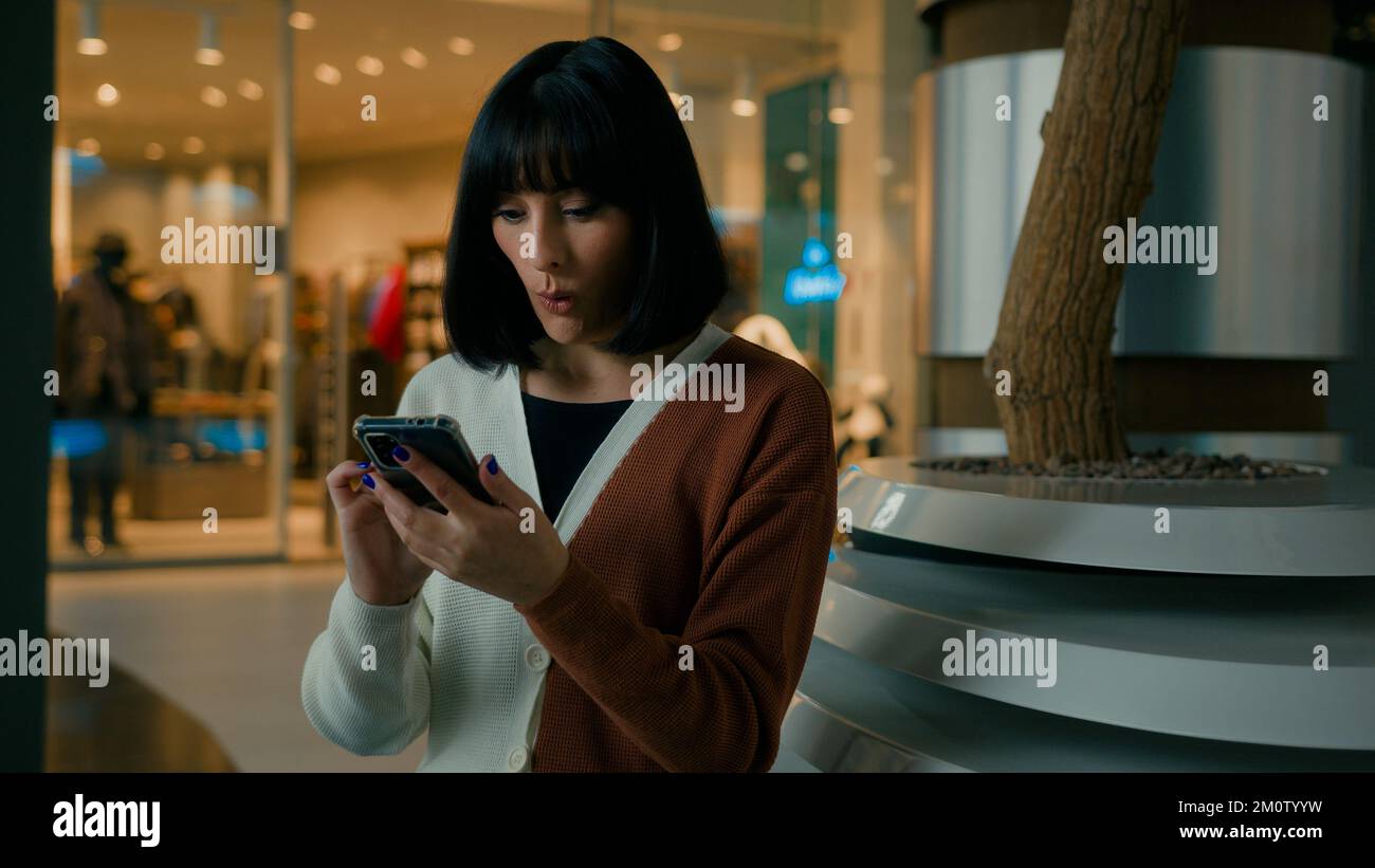 Happy shocked woman female girl win with mobile phone bet browsing ...