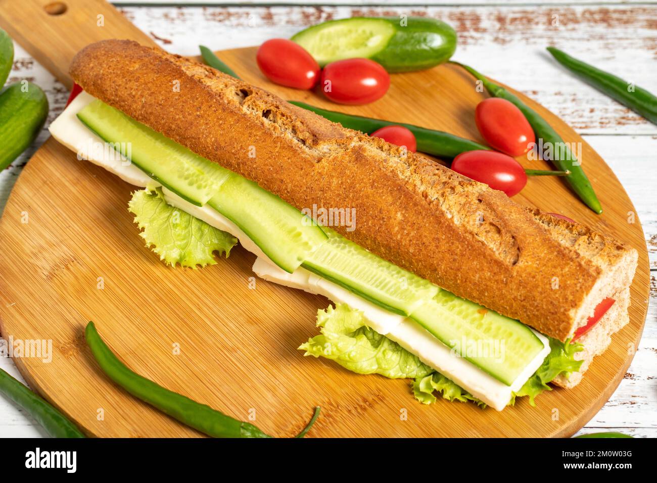 Baguette sandwich. Sandwich with olives, lettuce, tomato, cucumber ...