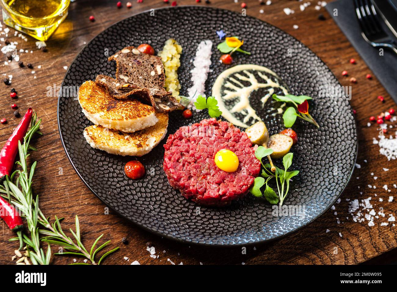 Beef tartare from Black Angus. Onion, quail egg, tomato sauce, mustard ...