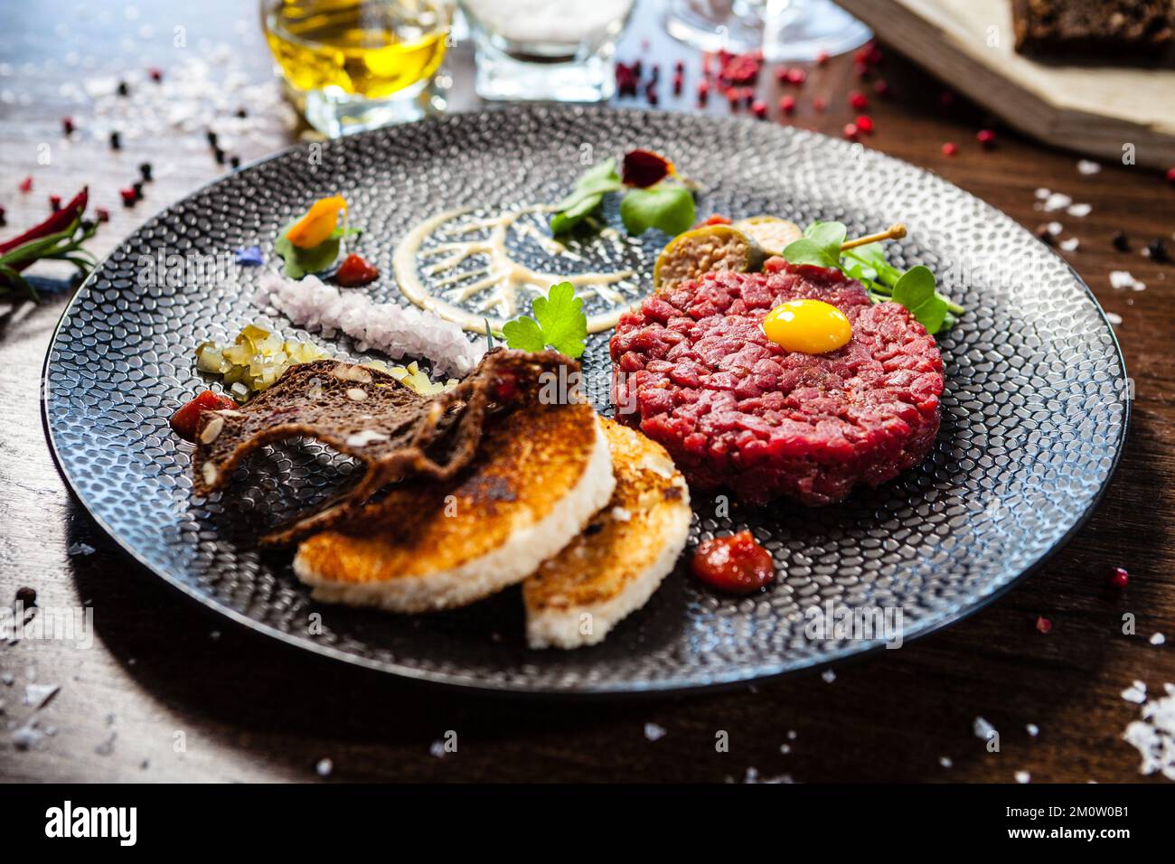Beef tartare from Black Angus. Onion, quail egg, tomato sauce, mustard ...