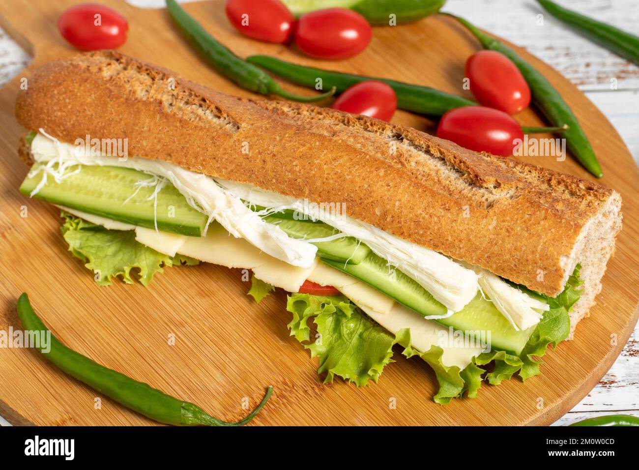 Baguette sandwich. Sandwich with olives, lettuce, tomato, cucumber ...