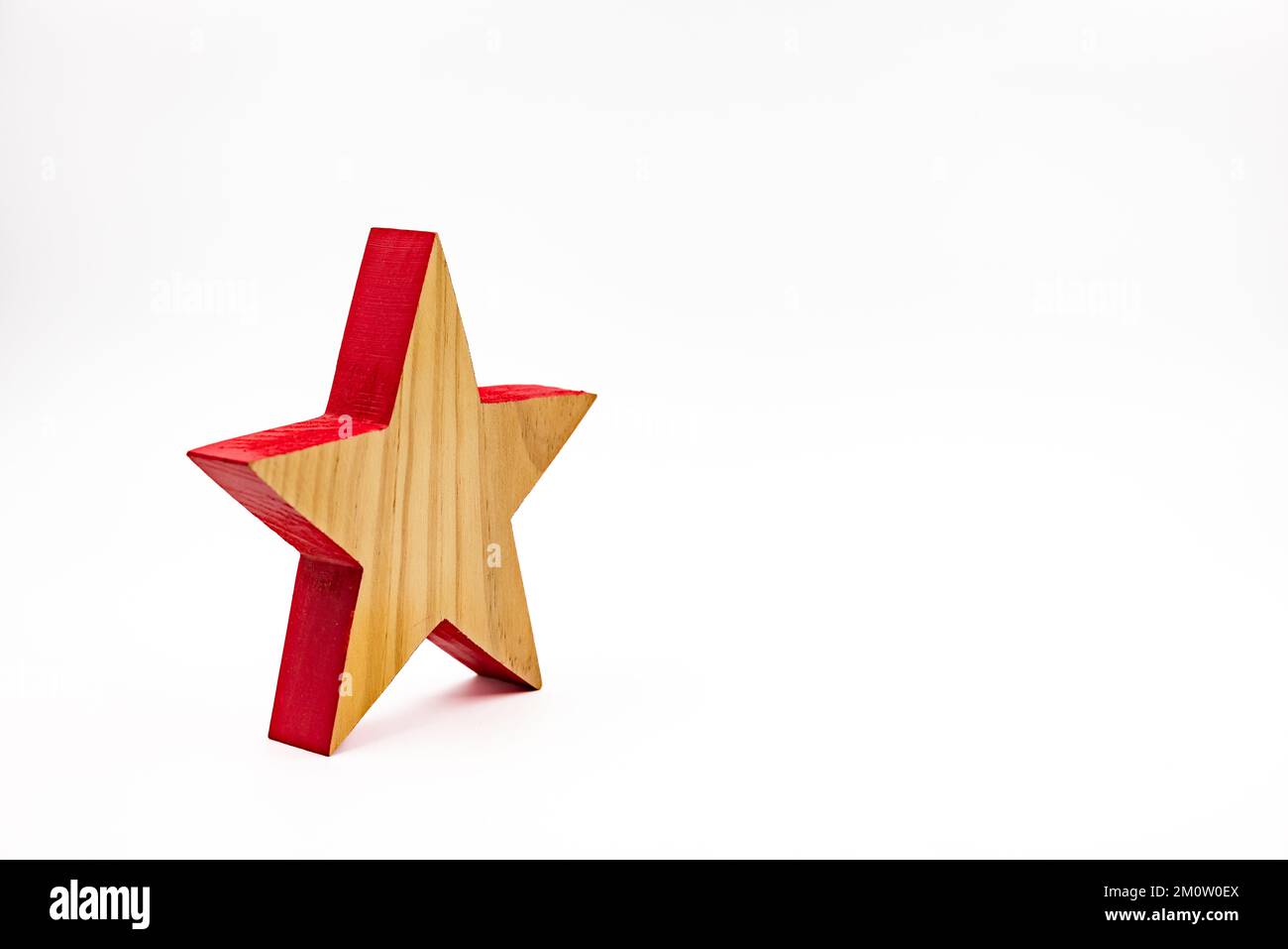 A wooden star with red edges isolated against a white background for ...