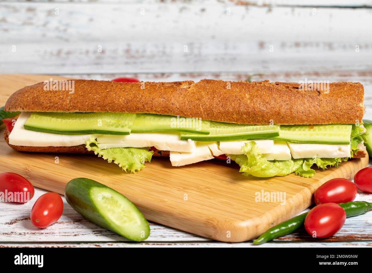 Baguette sandwich. Sandwich with olives, lettuce, tomato, cucumber ...