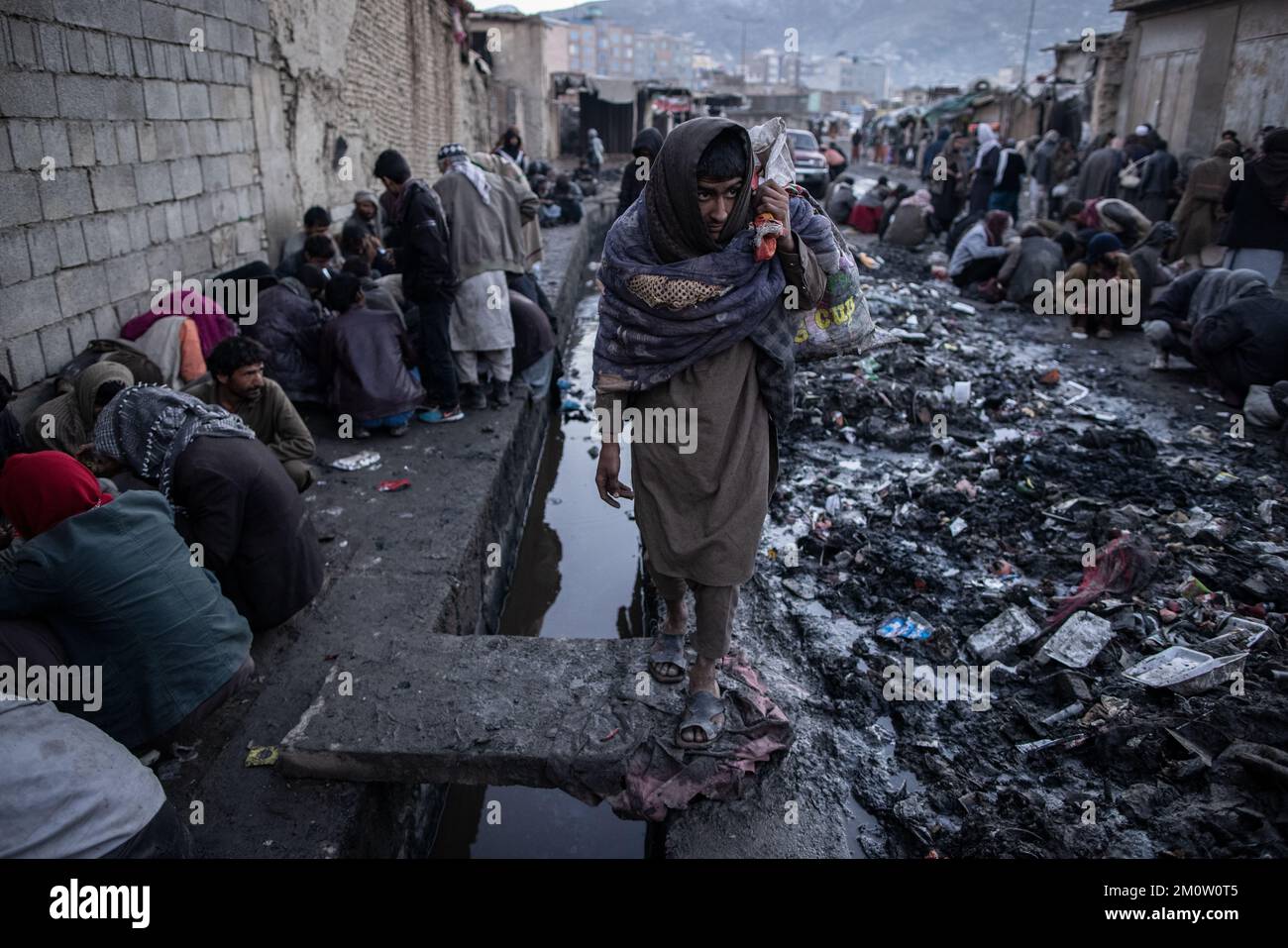 Kabul, Afghanistan. 14th Nov, 2022. Afghan men consume drugs on a side ...