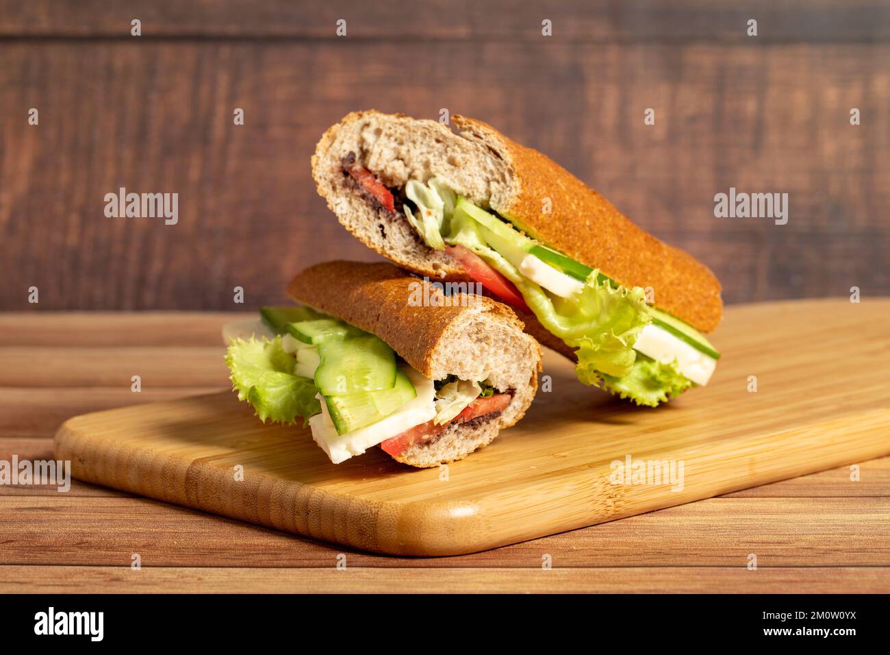 Baguette sandwich. Sandwich with olives, lettuce, tomato, cucumber ...