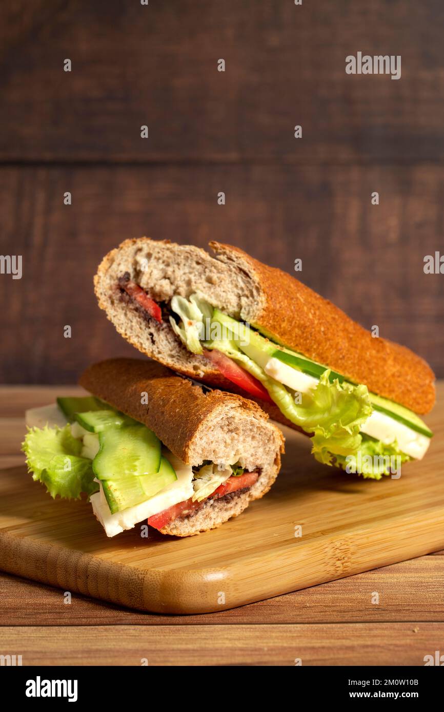 Baguette sandwich. Sandwich with olives, lettuce, tomato, cucumber ...