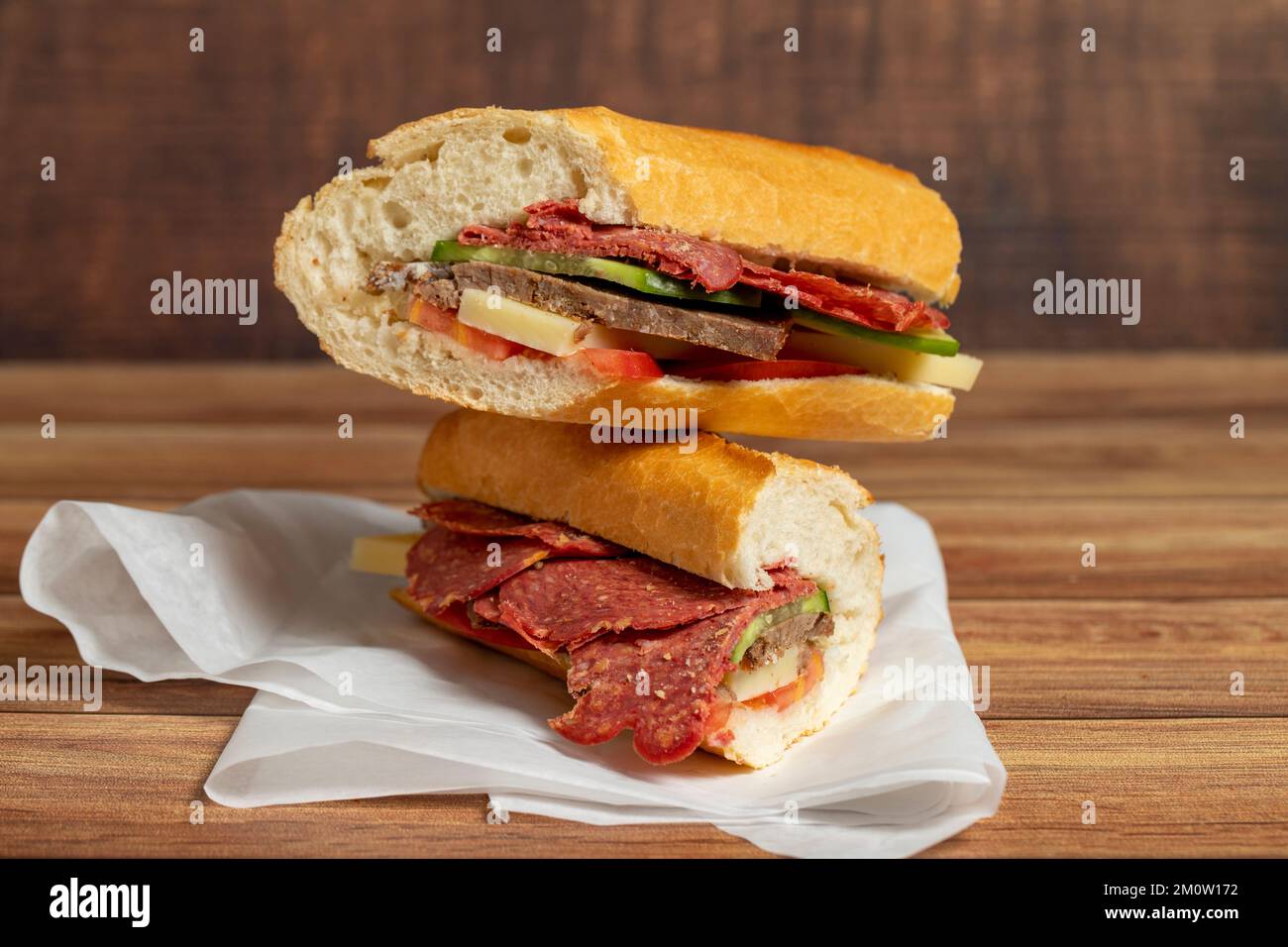 Baguette sandwich. Sandwich with salami, roast beef, cheddar, tomato ...