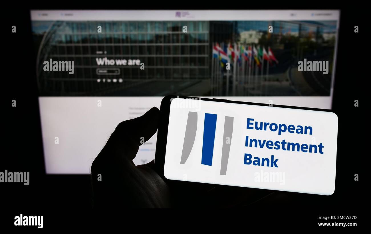 Person holding mobile phone with logo of EU institution European ...