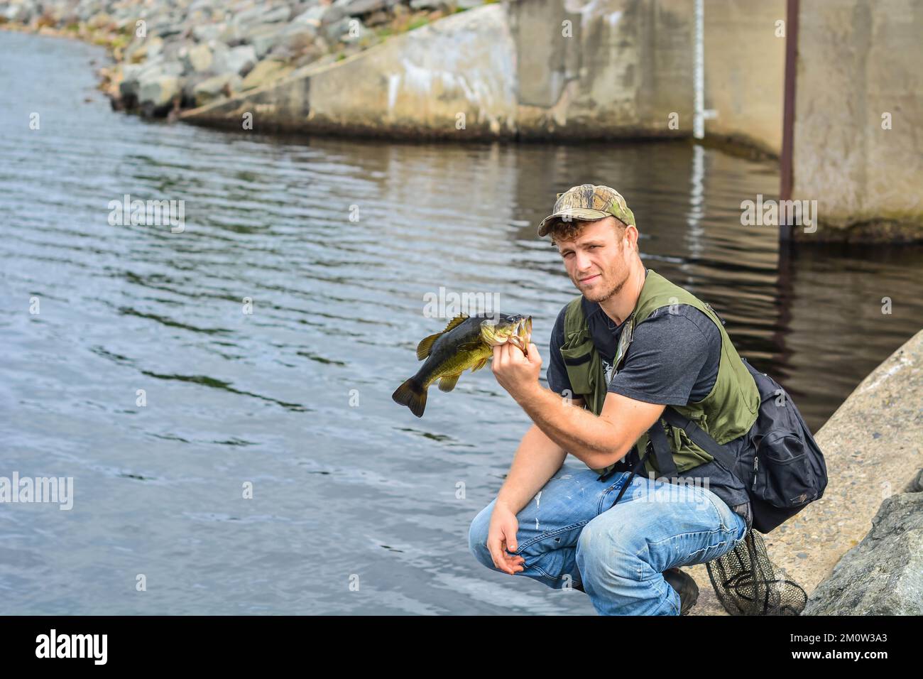 Fisherman with a great catch, largemouth bass trophy fish freshwater ...