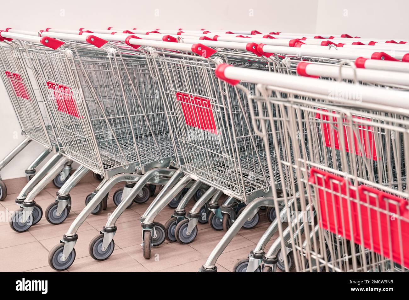 Many same shop trolley. Retail consumer carts. Empty parking store mall ...