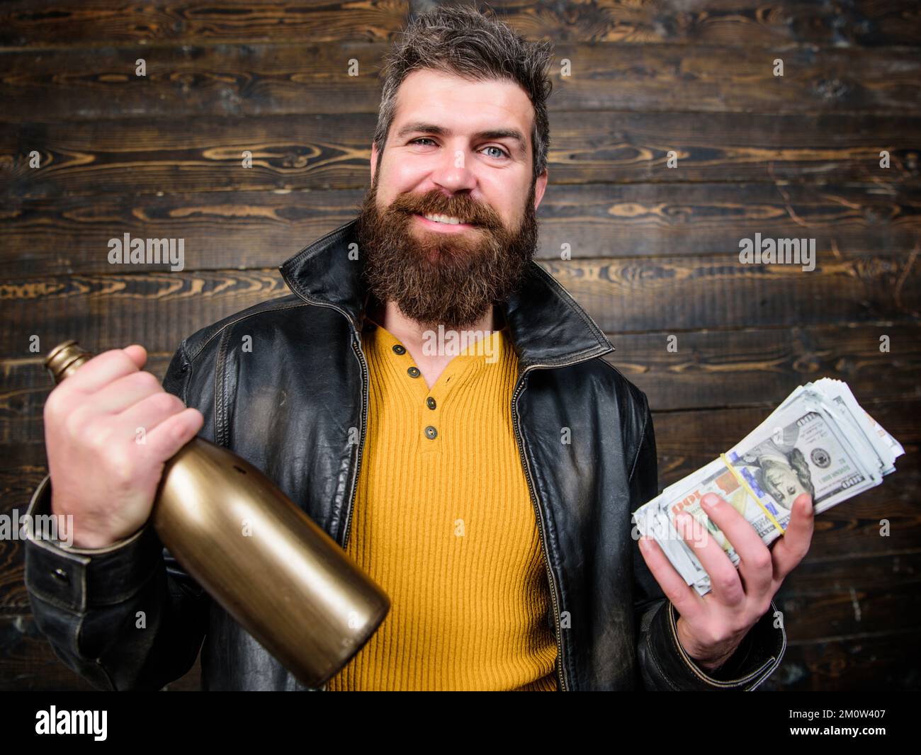 Celebrate profit. Man brutal bearded hipster wear leather jacket hold ...