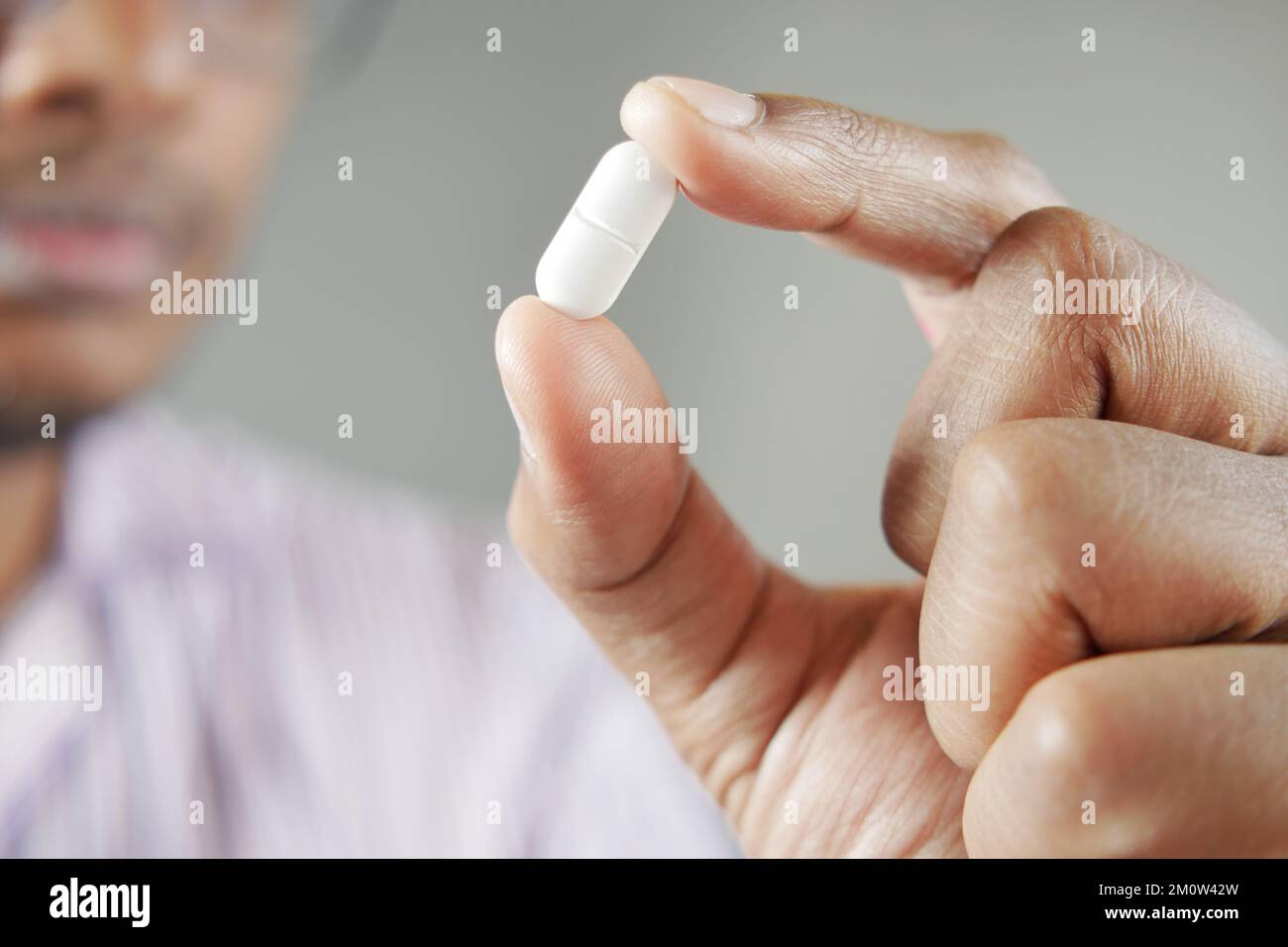Young men taking medical pill hi-res stock photography and images - Alamy