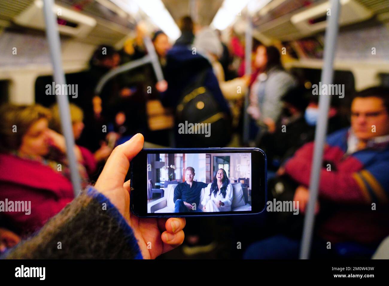 A phone screen held by a passenger on a London Underground tube train ...