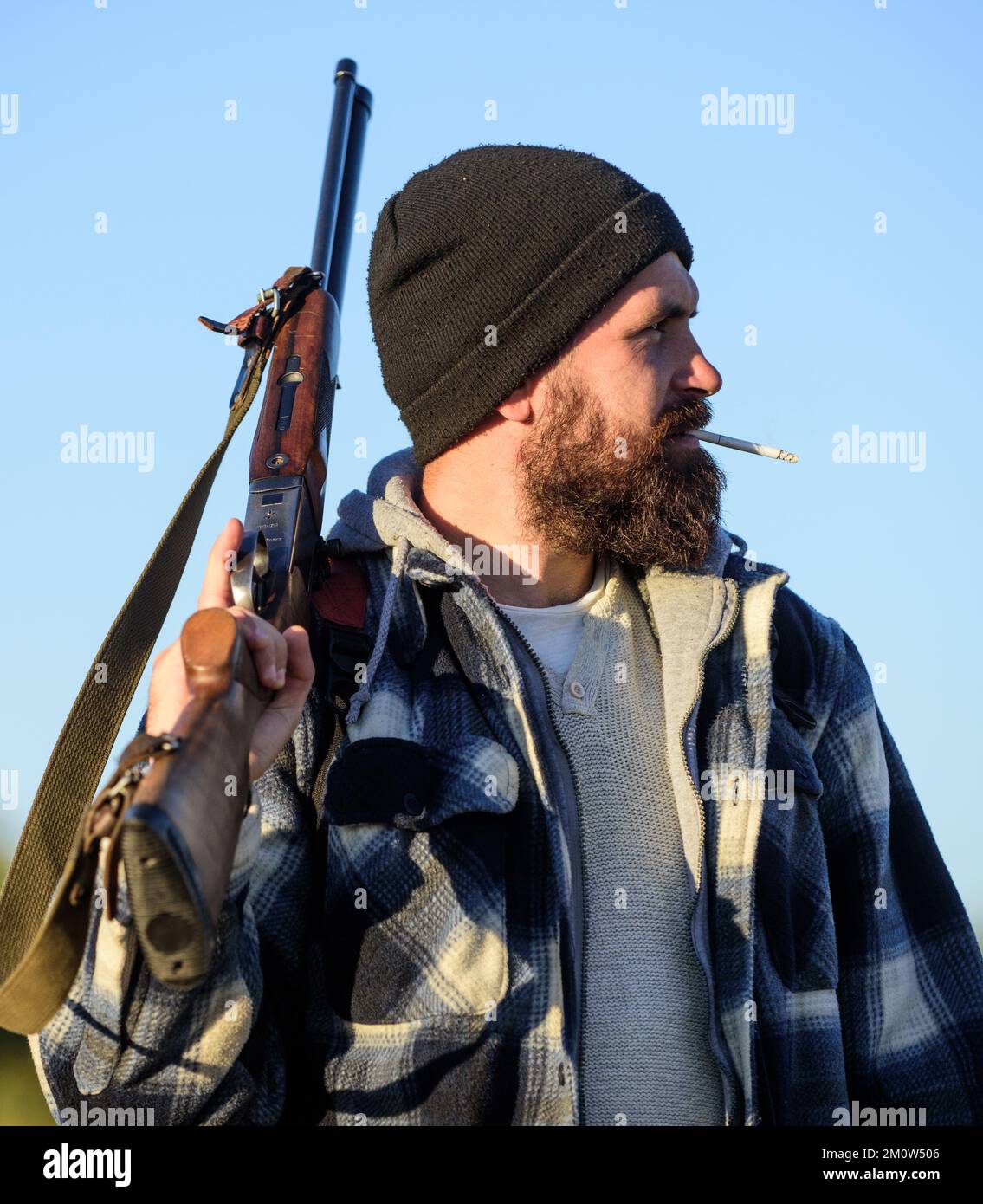 Hunting masculine hobby concept. Man brutal bearded guy gamekeeper blue ...