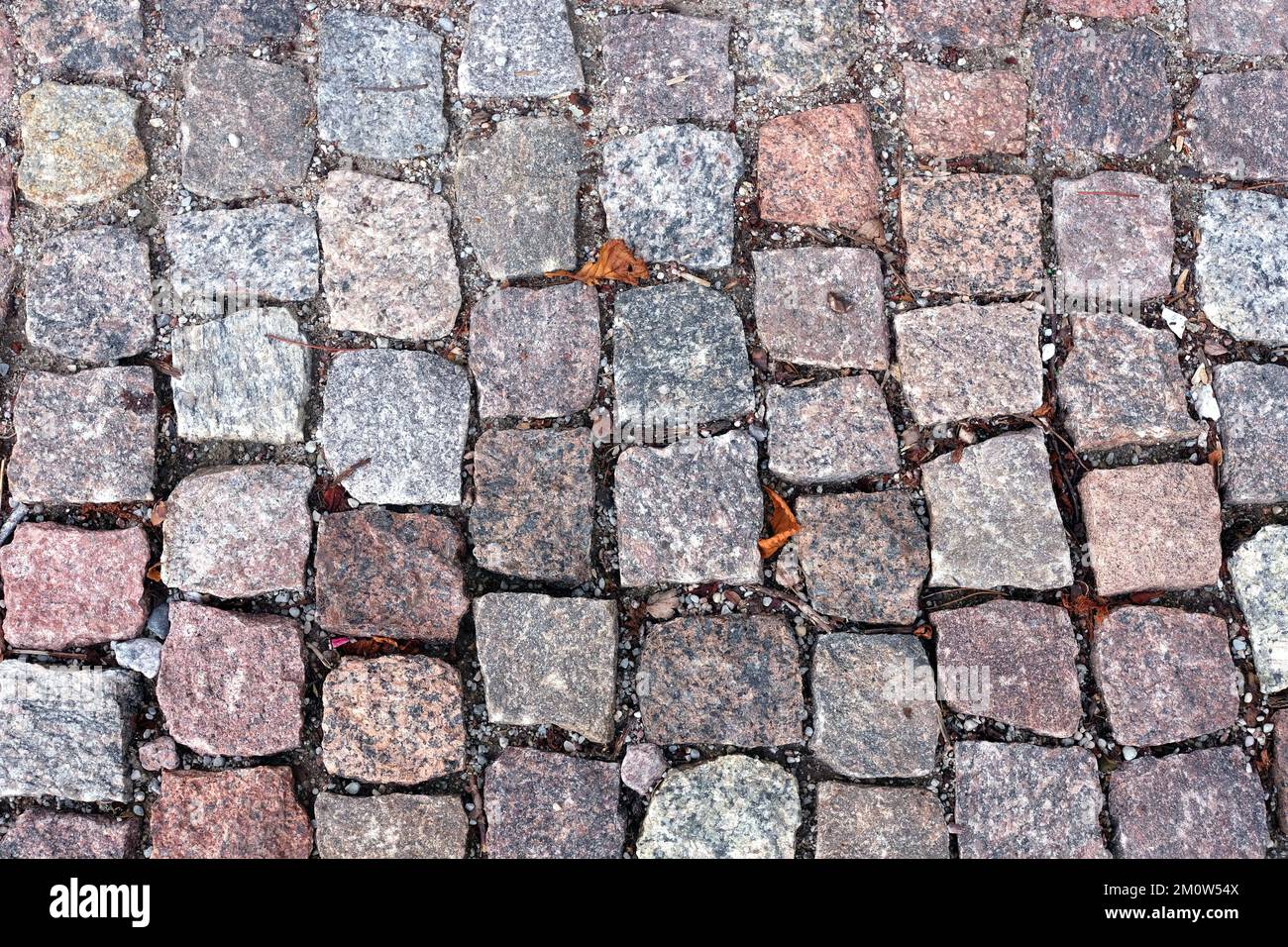 Old dark color paving cobblestone from rough blocks as background top ...