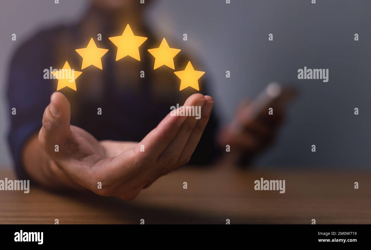 hand of customer or client holding the stars to complete five stars ...