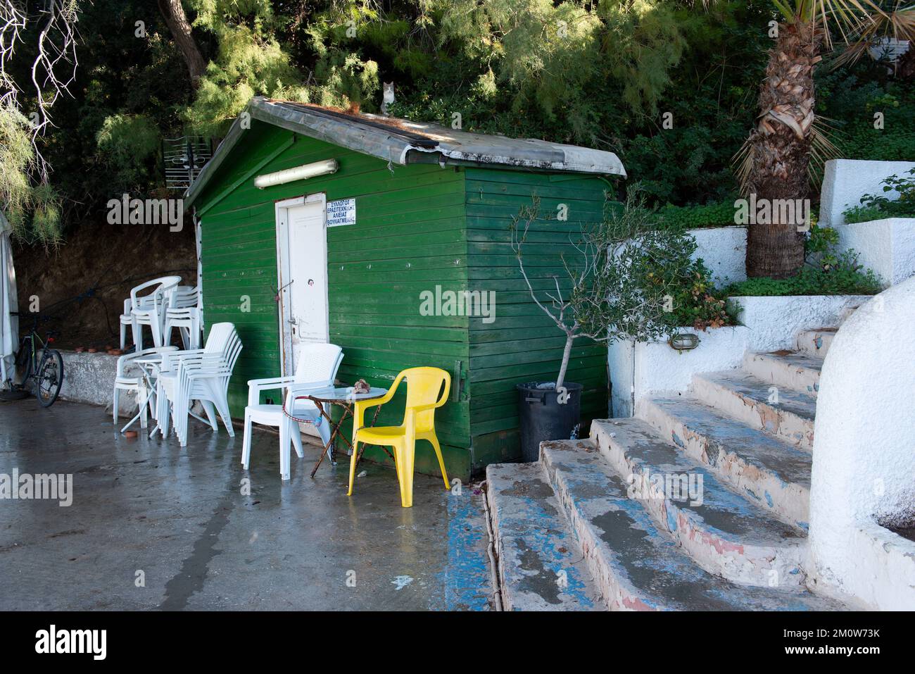 A small wooden green building on a beach for swimmers, at the Athenian ...