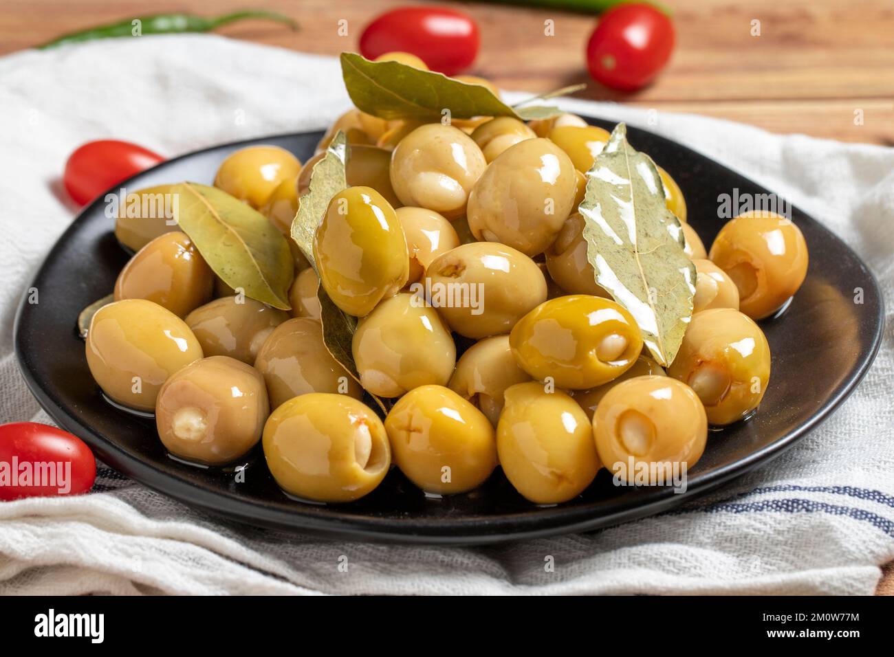 Green olives with cheese filling on a wooden background. Gourmet ...