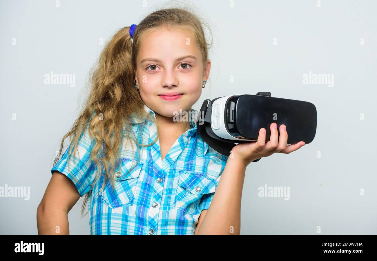 Small child wear wireless VR glasses. Little girl wearing virtual ...