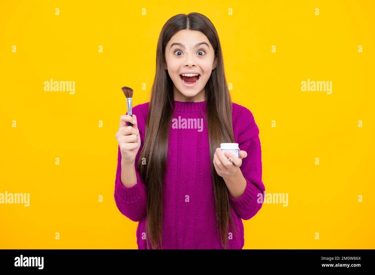 Excited face. Child teen girl making beauty make up, hold powder and ...
