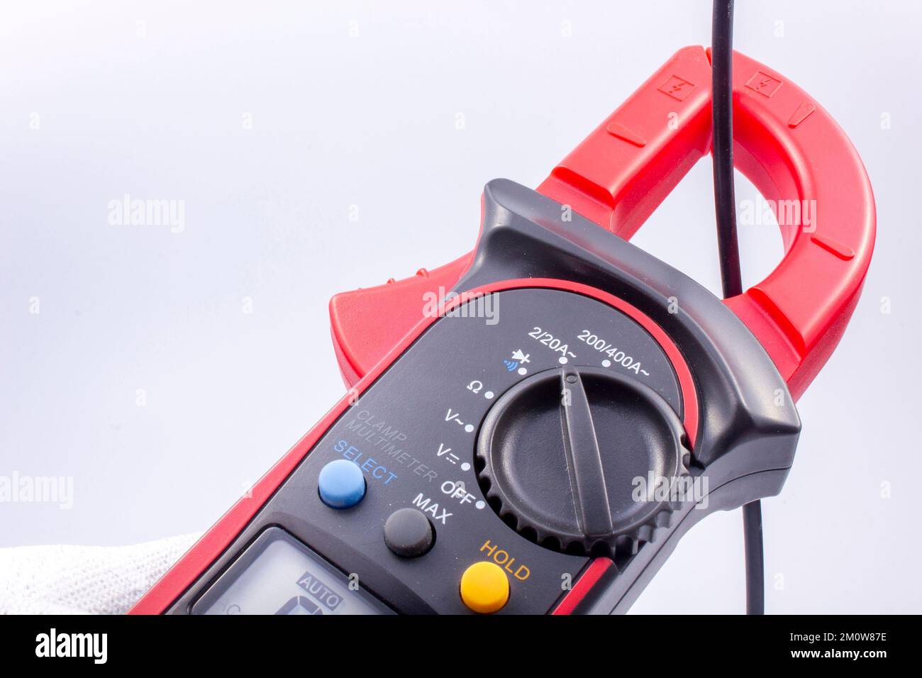 The electrician measures the current in the phase wire with a meter on ...