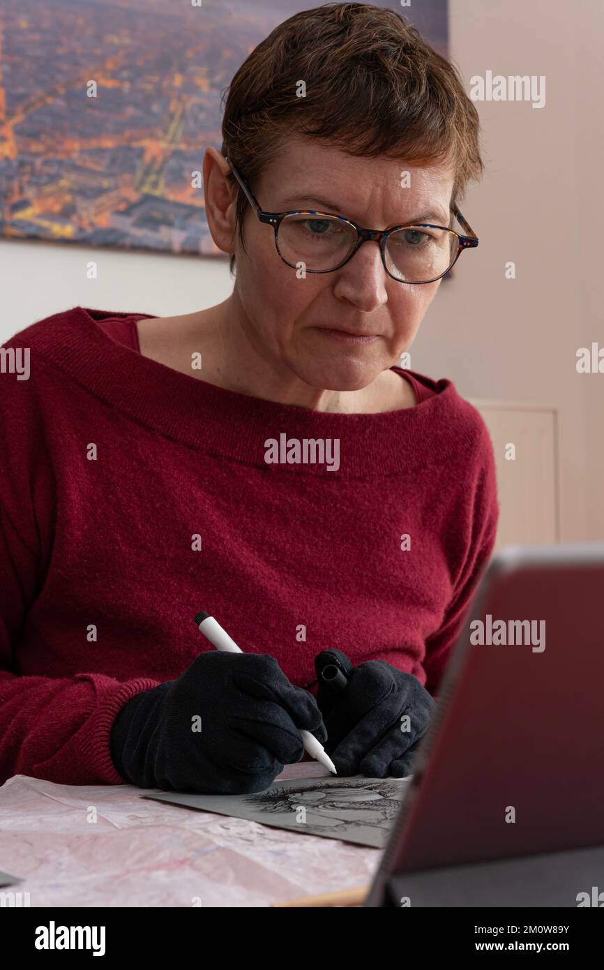 Woman draws in ink with a feather Stock Photo - Alamy