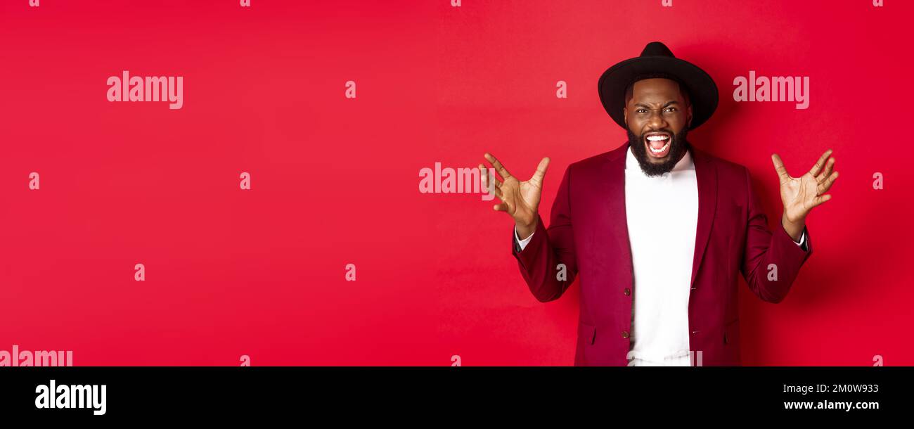 Angry Black man screaming and shaking hands with hatred, losing temper ...