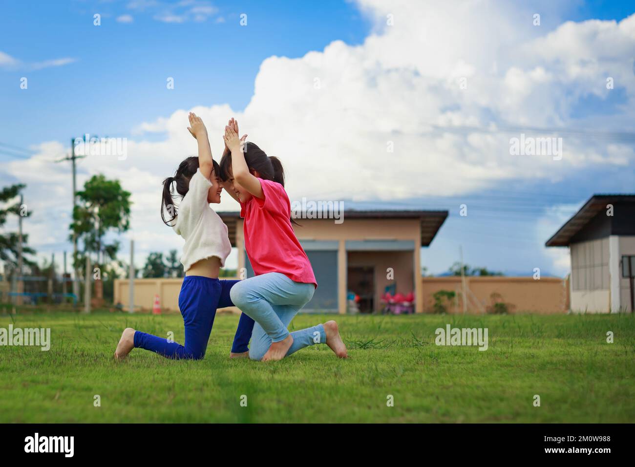 Children meditation with yoga pose on green grass field. Outdoors ...