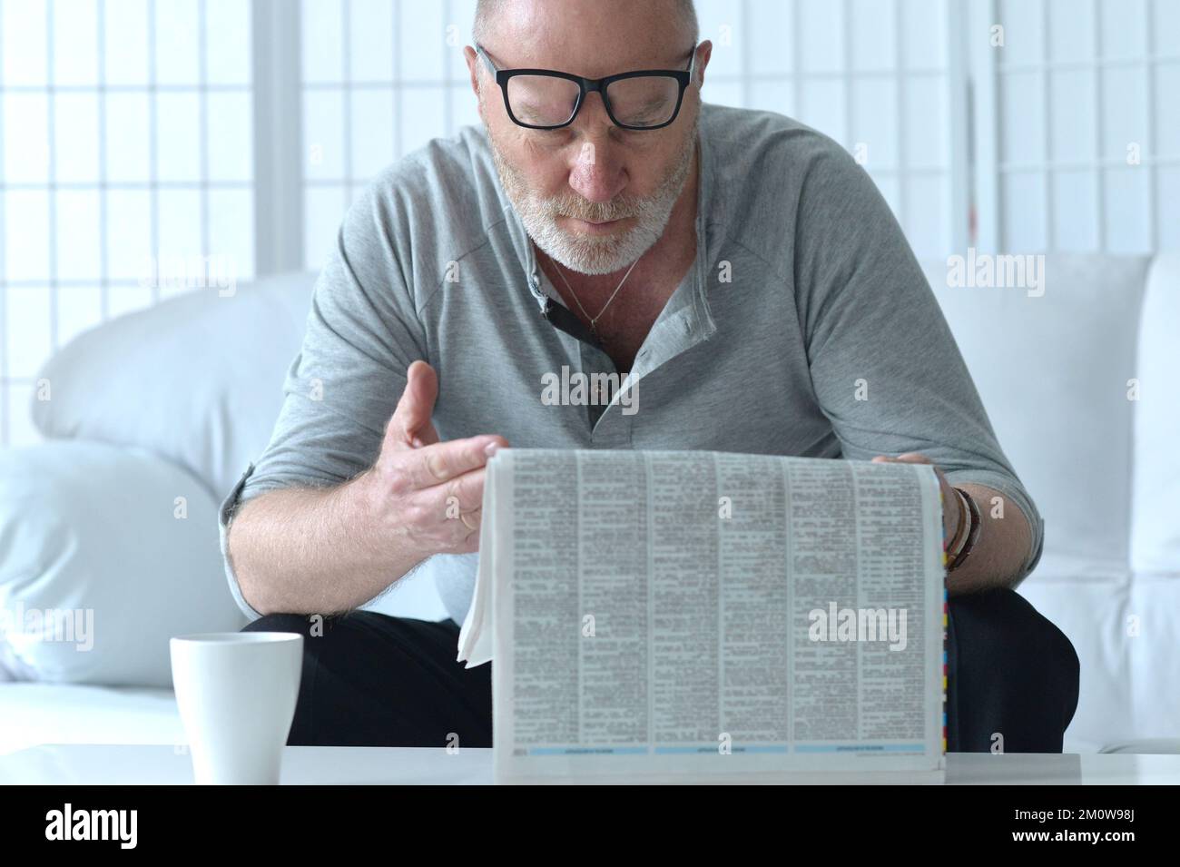 Senior old man reading newspaper at home Stock Photo - Alamy