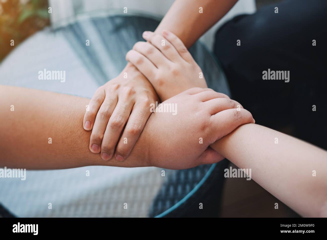 Business teamwork cooperation. Top view of people holding hands ...
