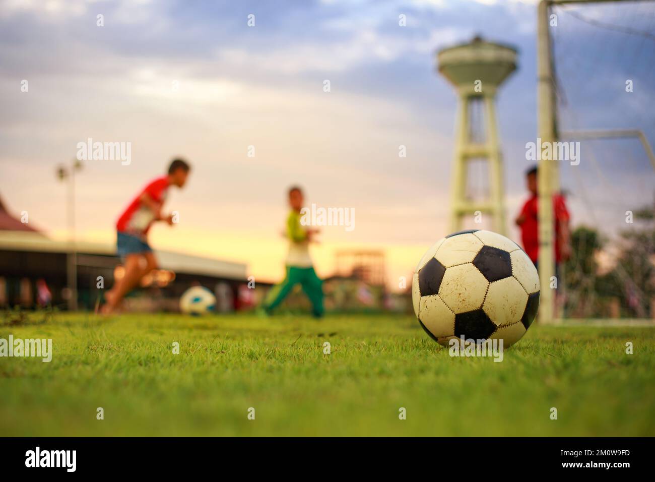 action sport outdoors of a group of kids having fun playing soccer ...