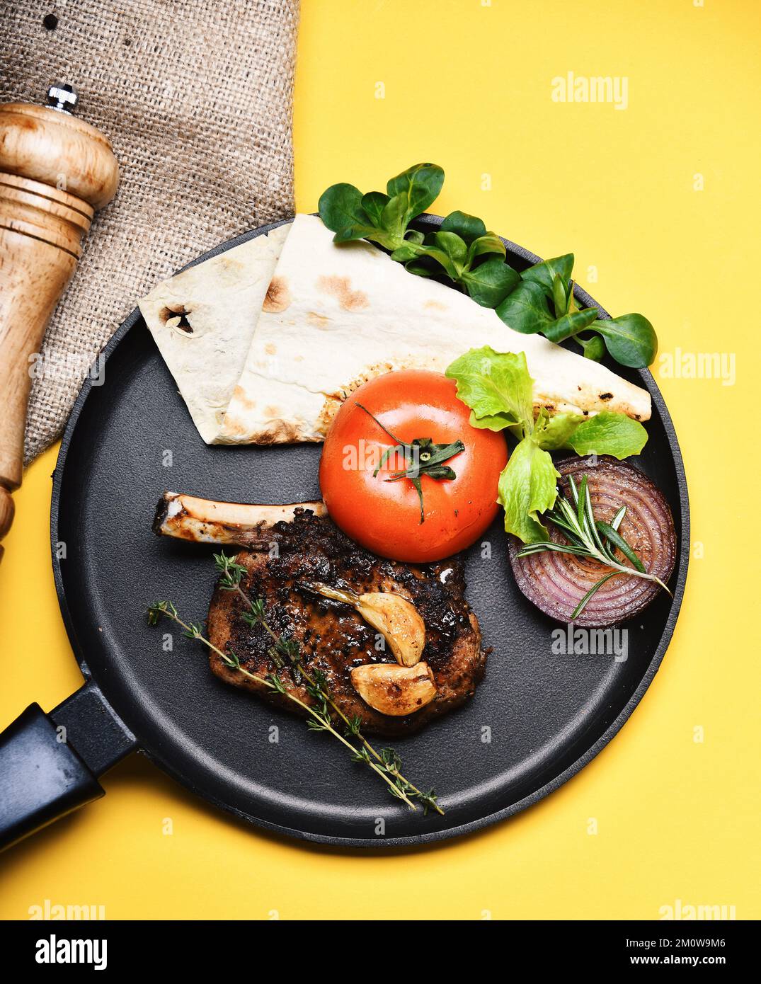Pork or lamb ribs with decor on frying pan Stock Photo - Alamy