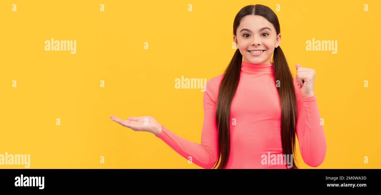 smiling kid presenting product, copy space. pretty teen girl ...