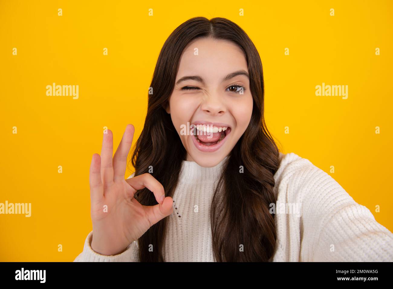 Teenager lifestyle. Beautiful ateenager child girl in moder suit making ...