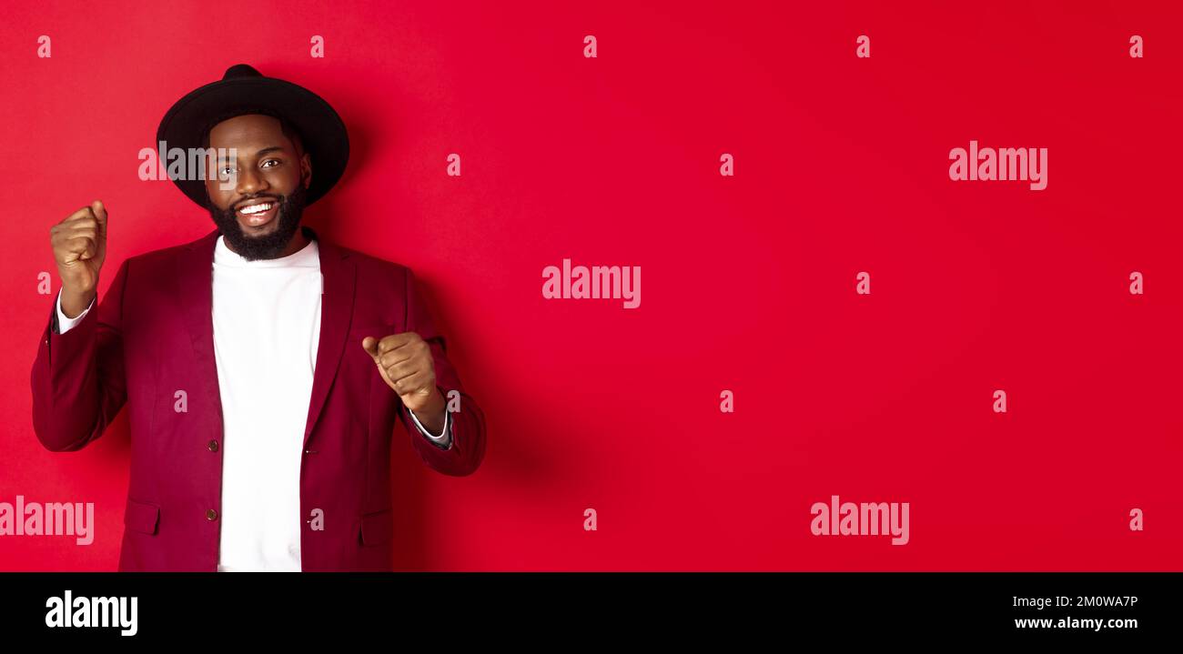 Fashion and party concept. Handsome Black man celebrating in jacket and ...