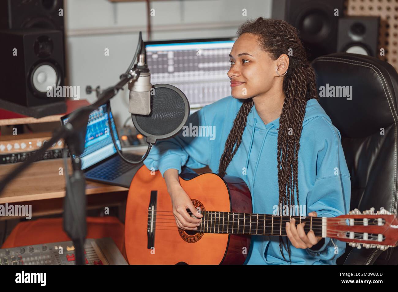 Charming talented teenage African girl guitarist recording new song in ...