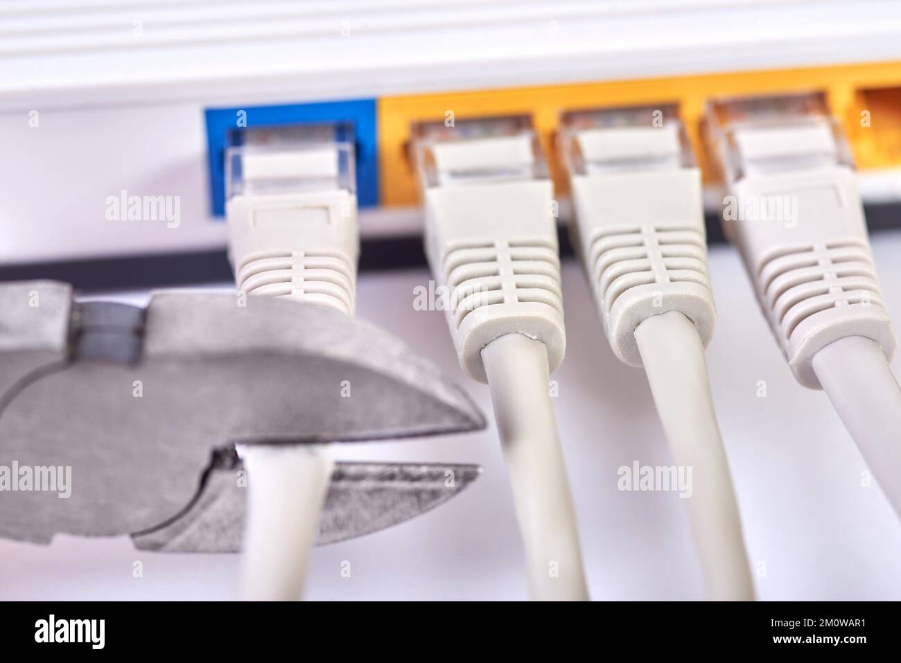 Wire cutters cuts the Internet cable into the router Stock Photo - Alamy