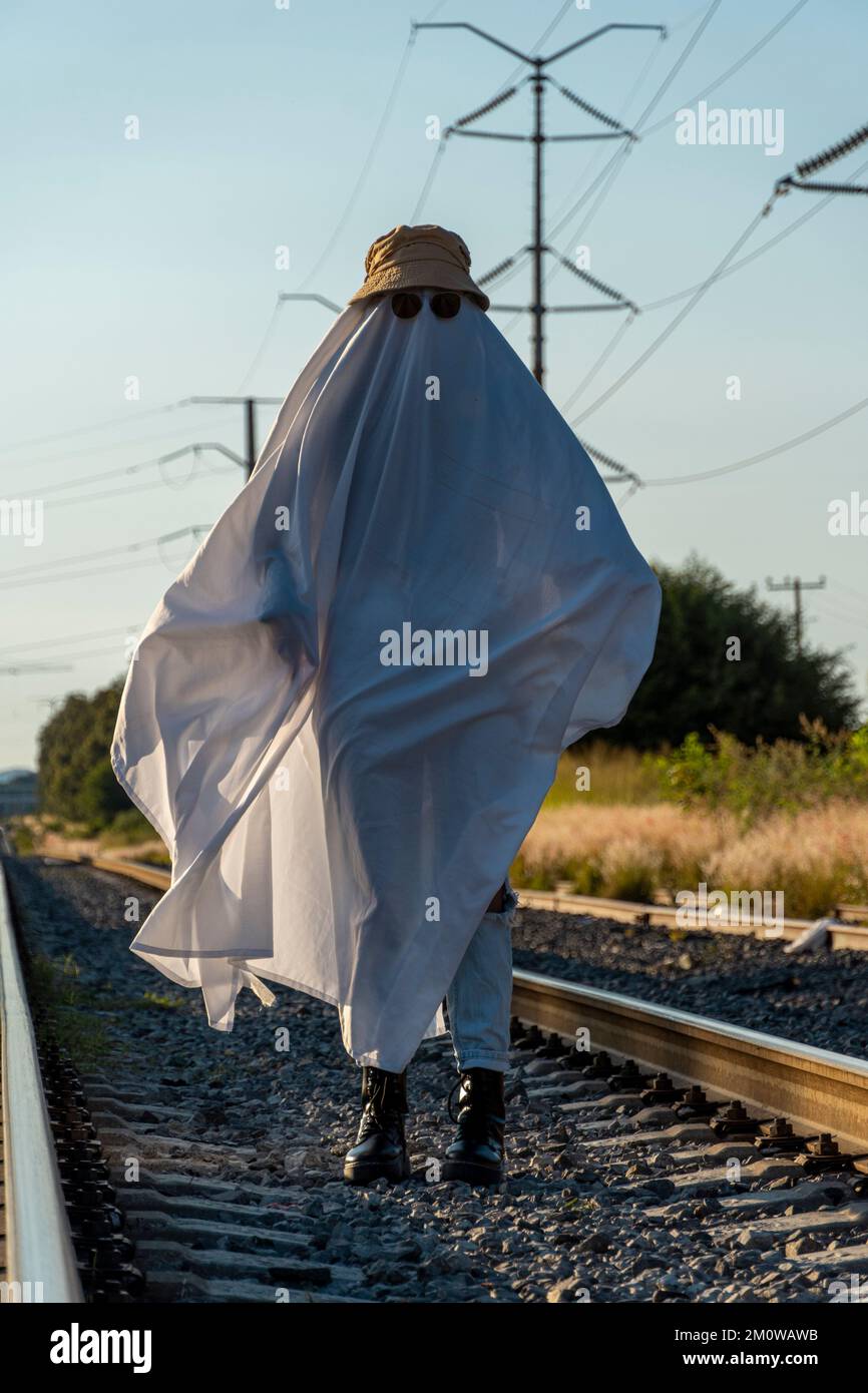 A ghost standing on the train tracks in the countryside - Halloween ...