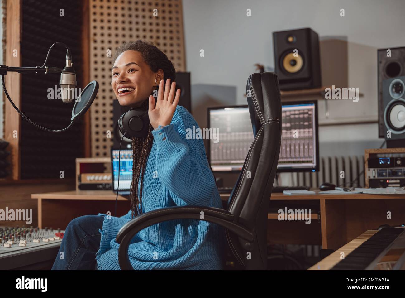 Pretty archorwoman, radio presenter greeting while talking into ...