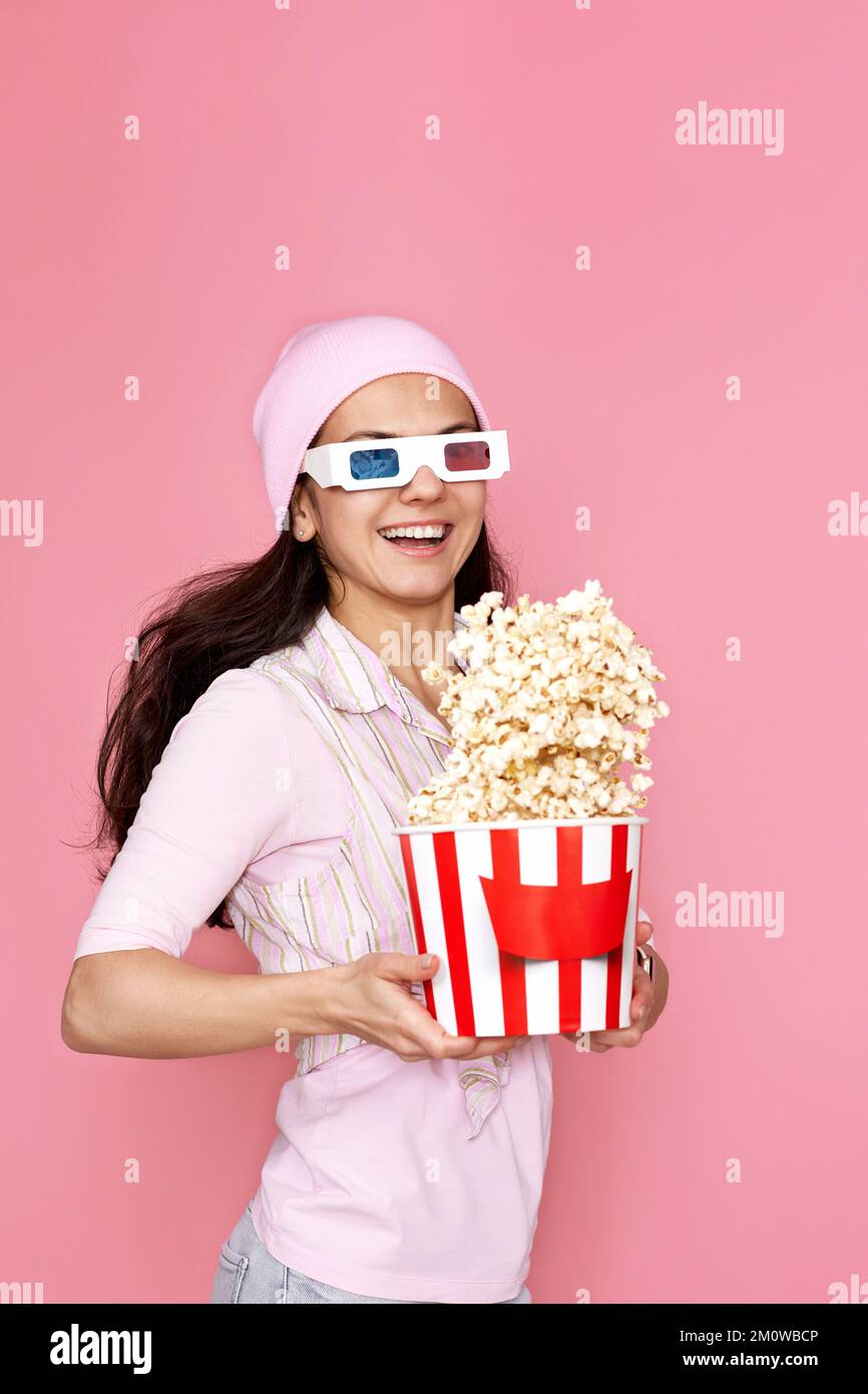 woman holding bucket of popcorn and jumping Stock Photo - Alamy