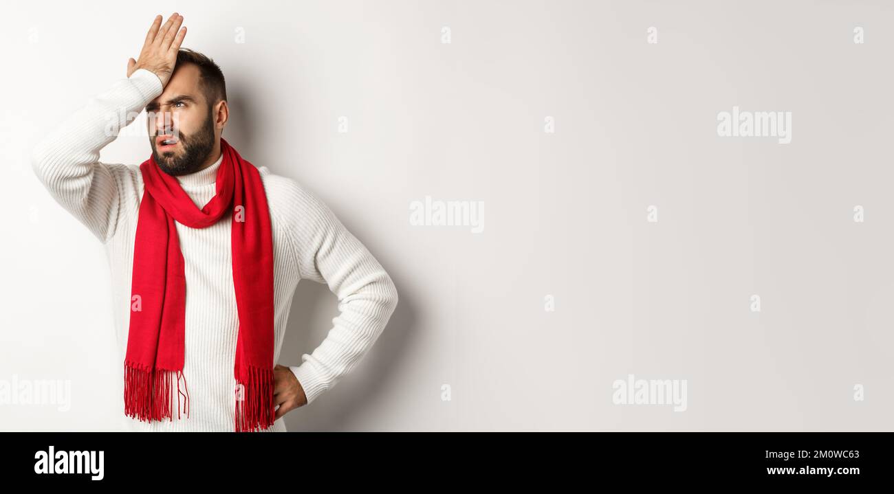 Annoyed man slap his forehead and cursing, forgetting buy christmas ...