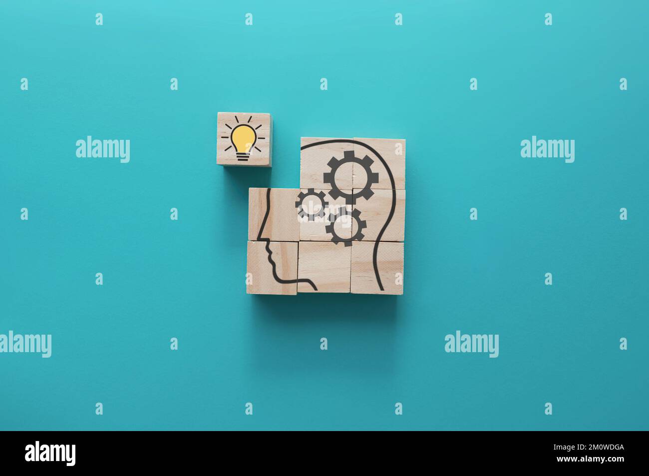 Human head outline on wooden blocks with missing piece light bulb ...