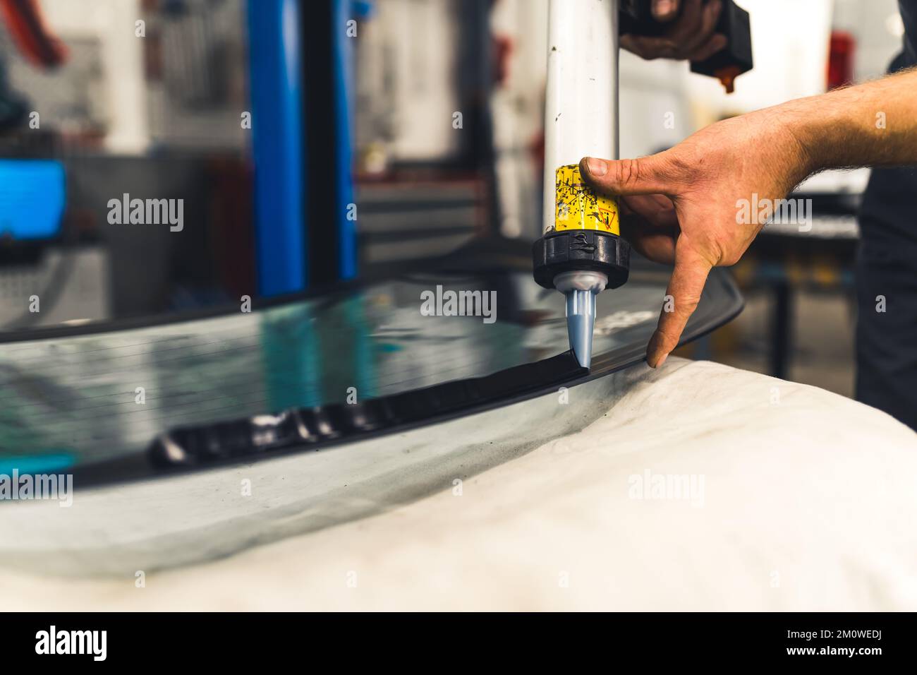 Vehicles and machine concept. Installation of car window. Closeup ...