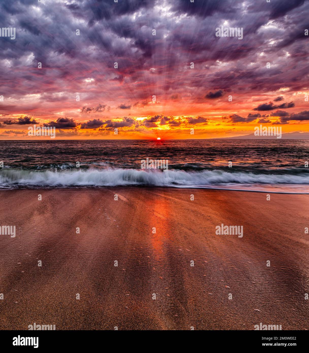 Sun Rays Are Bursting Forth Over A colorful Ocean Sunset In Vertical ...