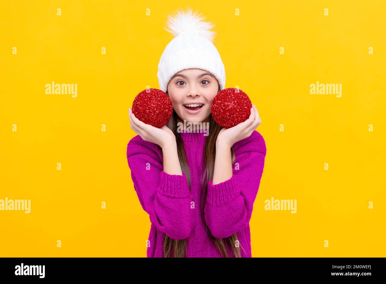 amazed kid in hat with snowballs on yellow background, new year Stock ...