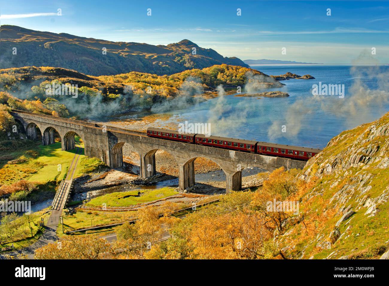 Jacobite Steam Train coaches entering the Nan Uamh Viaduct with clouds ...