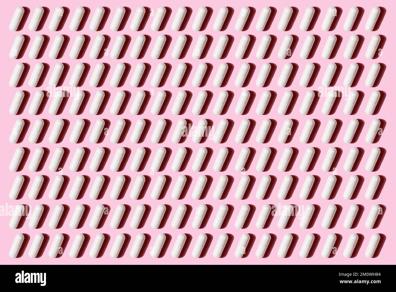 A Row Pattern White Pill Capsule Isolated On Pink Background, Medical ...